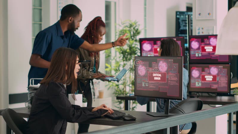Diverse Group Of Engineers Having Computer Hacked And System Crash On Multiple Monitors Stock