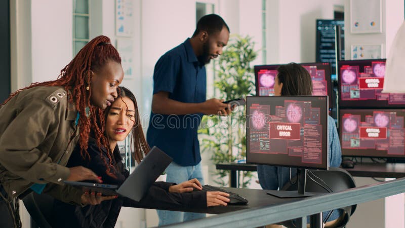 Diverse Group of Engineers Having Computer Hacked and System Crash on Multiple Monitors Stock ...