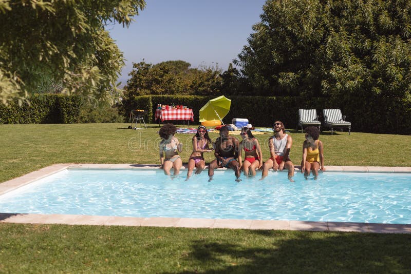 Diverse Group of Friends Talking and Sitting at the Poolside Stock ...