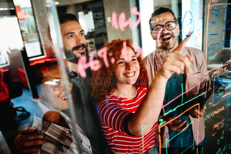 Diverse Group of Happy Employees Analyzing Reports with Digital Device ...