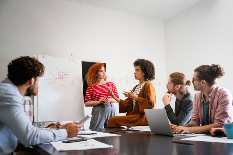 Diverse Group of Happy Employees Analyzing Reports with Digital Device ...