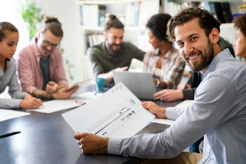 Diverse Group of Happy Employees Analyzing Reports with Digital Device ...