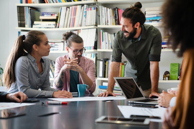 Diverse Group of Happy Employees Analyzing Reports with Digital Device ...
