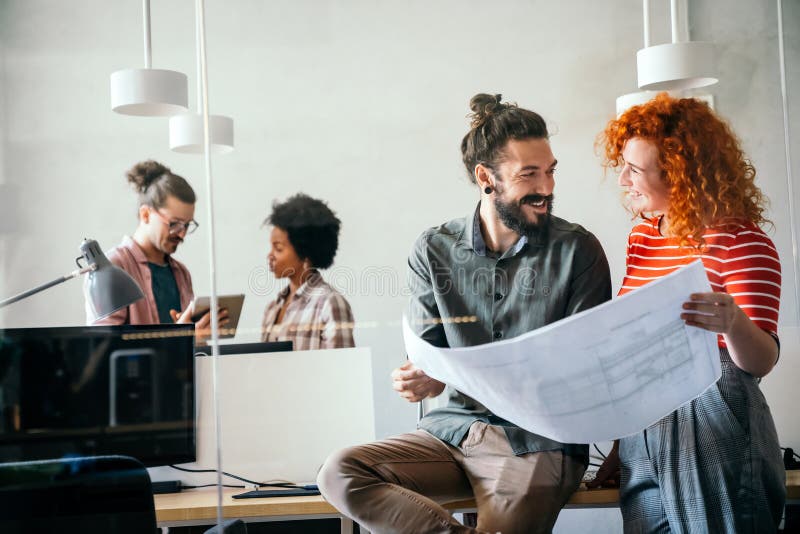 Diverse Group of Happy Employees Analyzing Reports Together with Papers ...