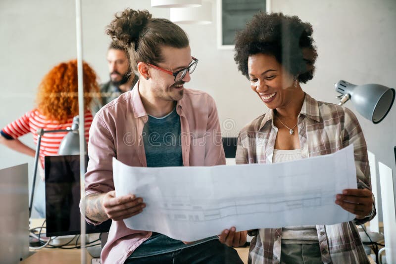Diverse Group of Happy Employees Analyzing Reports Together with Papers ... Diverse Group of Happy Employees Analyzing Reports Together with Papers ...