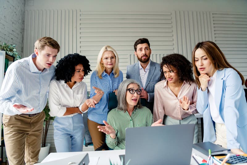 Group of Office Workers Collaborating Around a Laptop in a Modern ...