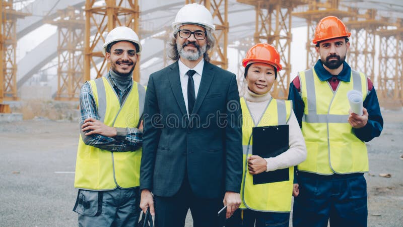Diverse Group of People Building Team Standing Outdoors in Construction ...