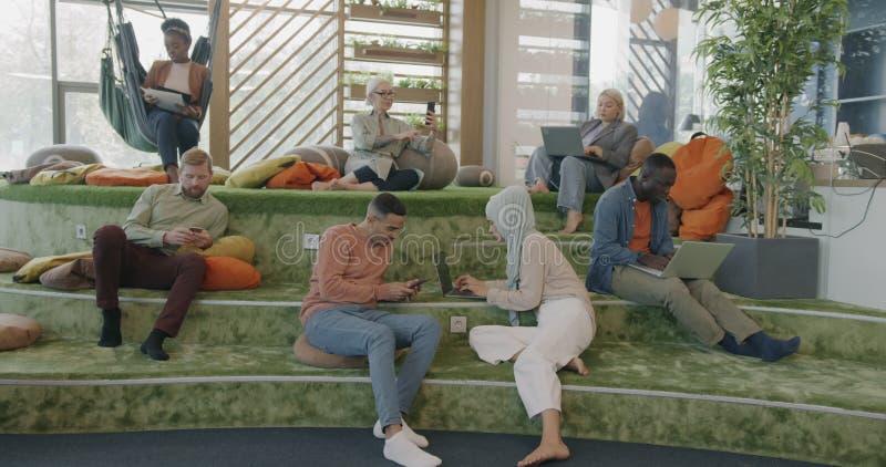 Diverse Group of People Working with Laptops in Modern Coworking Center ...