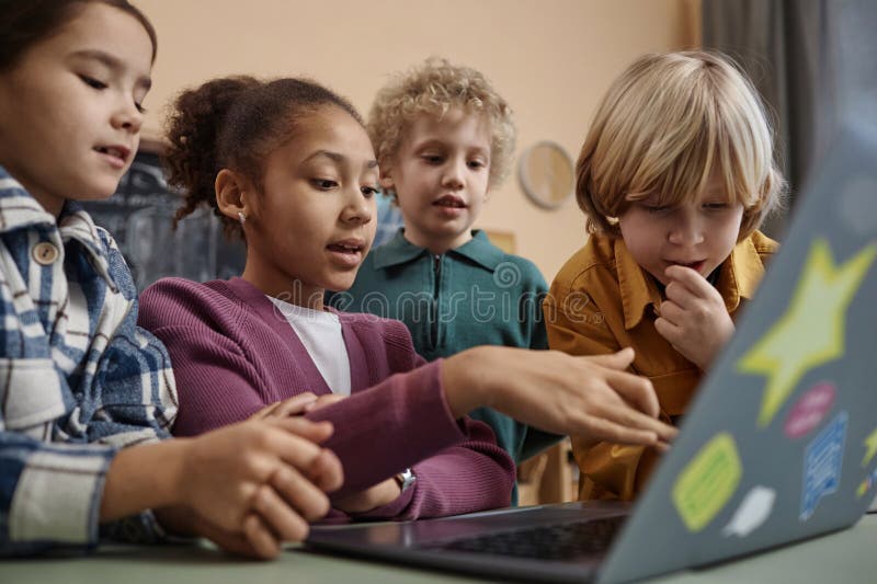 Diverse Group of School Children Looking at Computer Screen Together ...