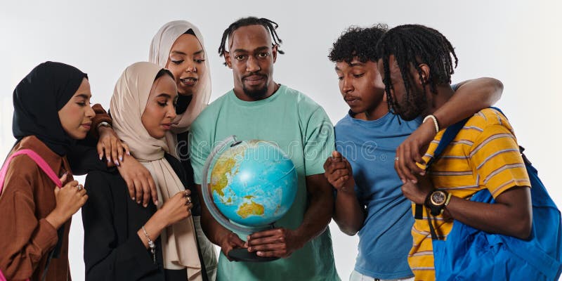 A Diverse Group of Students is Gathered Around a Globe, Engrossed in ...