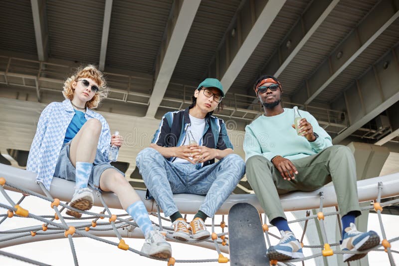 Diverse Group of Three Young People Hanging Out in Urban Setting Stock ... Diverse Group of Three Young People Hanging Out in Urban Setting Stock ...