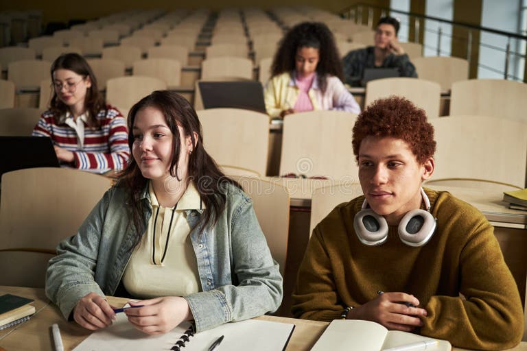 Diverse Group of University Students Attending Lecture in Classroom ...