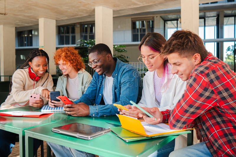 Diverse Group of University Students Collaborating on Their Studies and Sharing Information ...