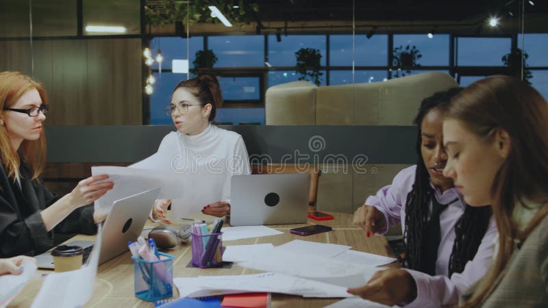 A Diverse Group of Women is Actively Collaborating in a Modern Meeting ...
