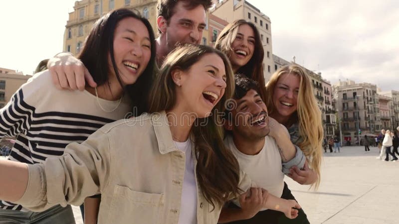Diverse Group Of Young Adult Friends Having Fun Hugging Each Other