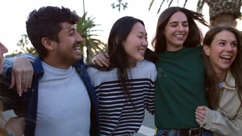Diverse Group Of Young Adult Friends Having Fun Hugging Each Other