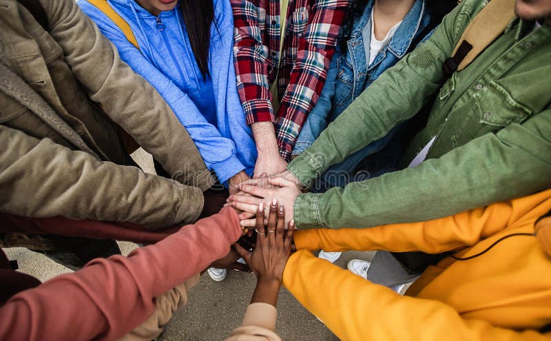 Diverse Group of Young Friends Stacking Hands Outdoors Showing Support ...