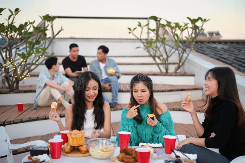 Diverse Group of Young People Hanging Out on a Rooftop in the Evening ...
