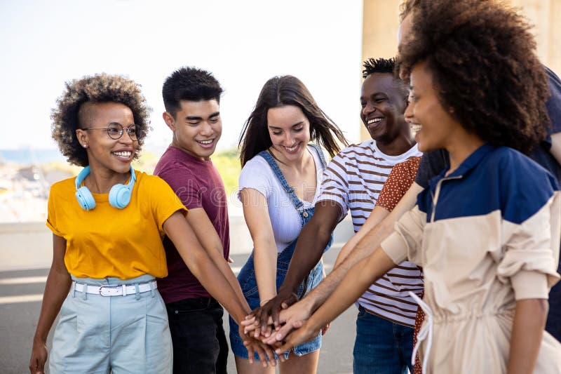 Young Group of Happy Diverse Friends Laughing while Walking Together ...