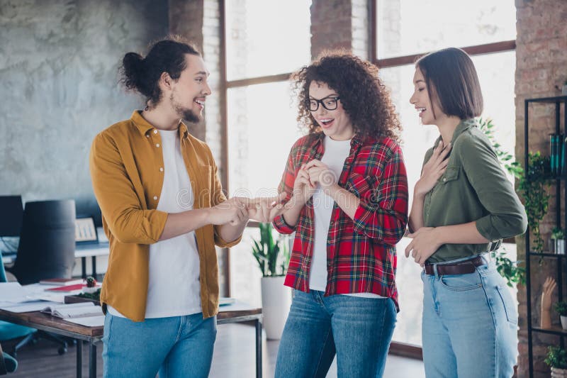 Young Diverse Team Engaged in Discussion while Collaborating in a ...