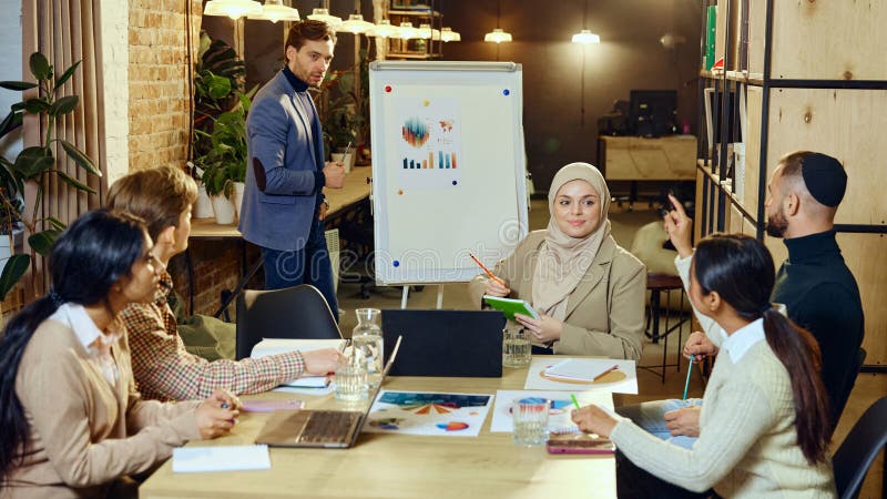 Diverse Group of Young Professionals Gathered Around Table, Discussing ...