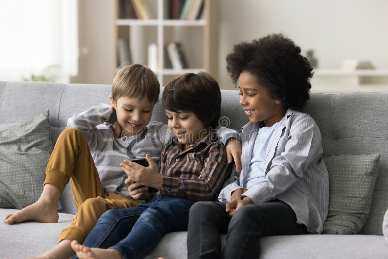 Diverse Kids Sit on Sofa Use Smartphone Stock Photo - Image of boys ...