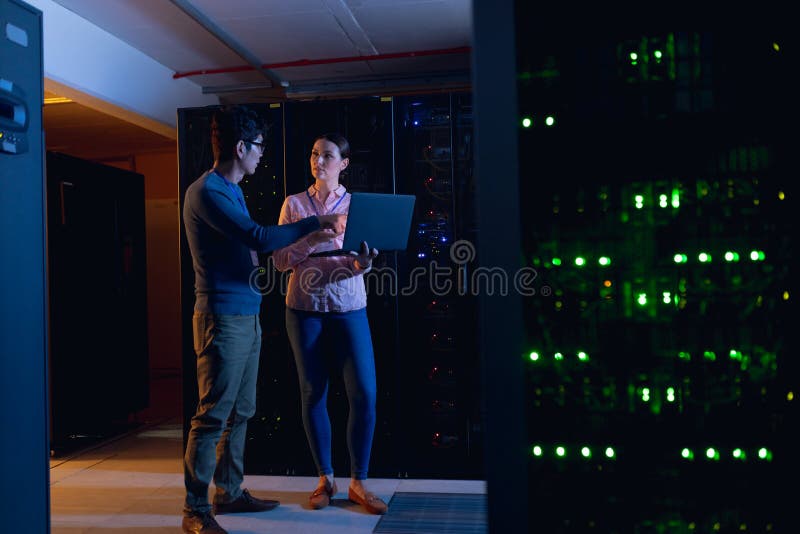 Diverse Male and Female Engineers Using Laptop in Computer Server Room Stock Image - Image of ...