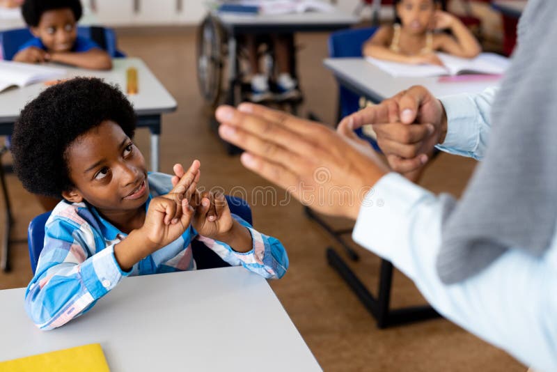Diverse Male Teacher Teaching School Boy Using Sign Language in Class ...