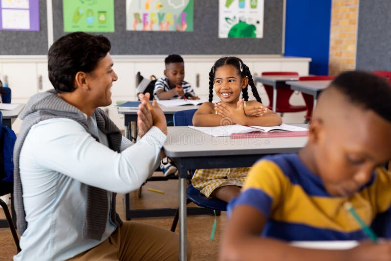Diverse Male Teacher Teaching School Boy Using Sign Language in Class ...