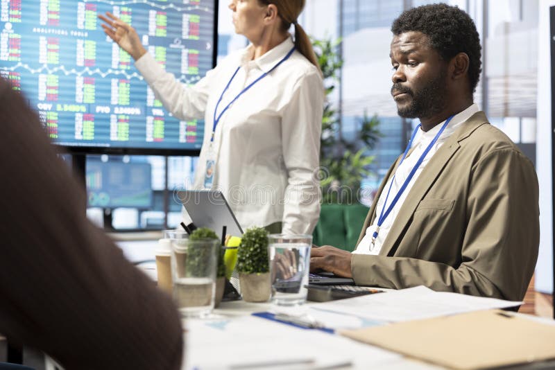 Diverse Management Team Evaluates Budget Reports on Interactive Board ...