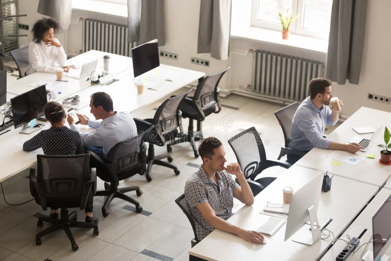 Diverse Office Workers Using Computers in Modern Corporate Space Stock ...