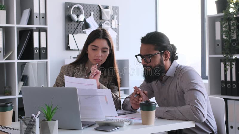 Two Diverse Office Workers Engaged in Teamwork, Analyzing Documents and ...