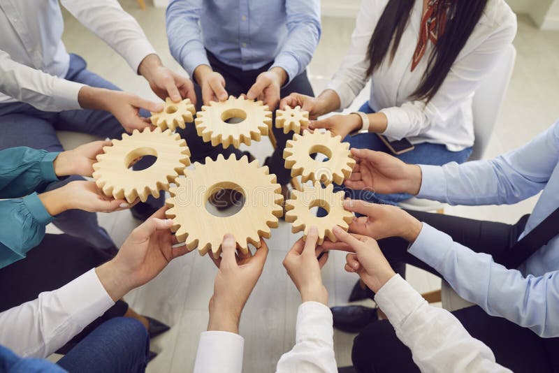Diverse People Hands Assembling Gear Puzzle Mechanism for Common ...