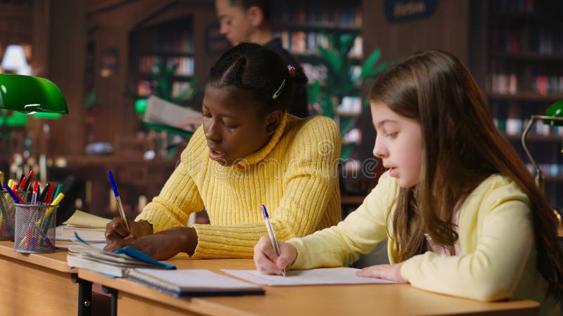 Diverse Scholars Helping Each Other Finish the Homework at the Library ...