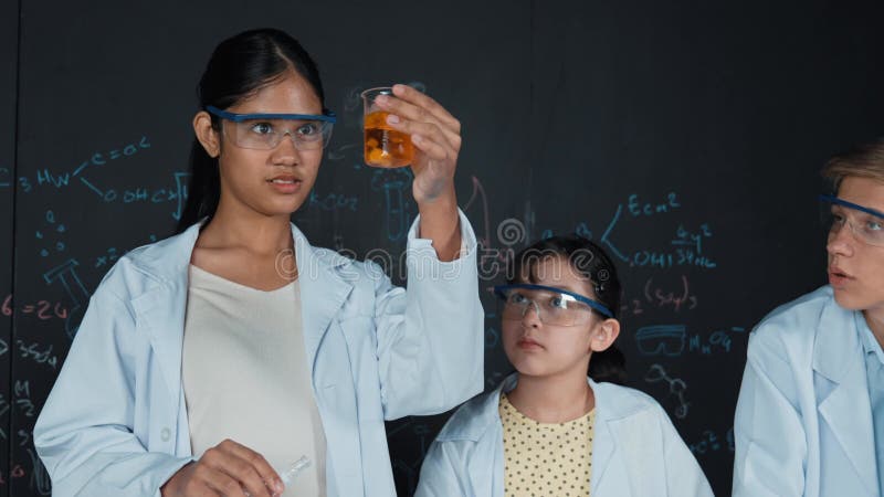 Diverse Student Mixing Colored Solution while Doing Experiment ...