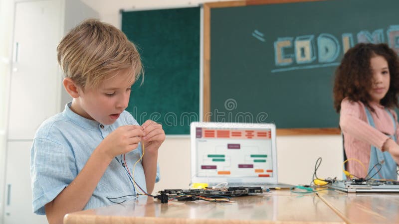 Diverse Student Working Electronic Board while Laptop Display Prompt ...