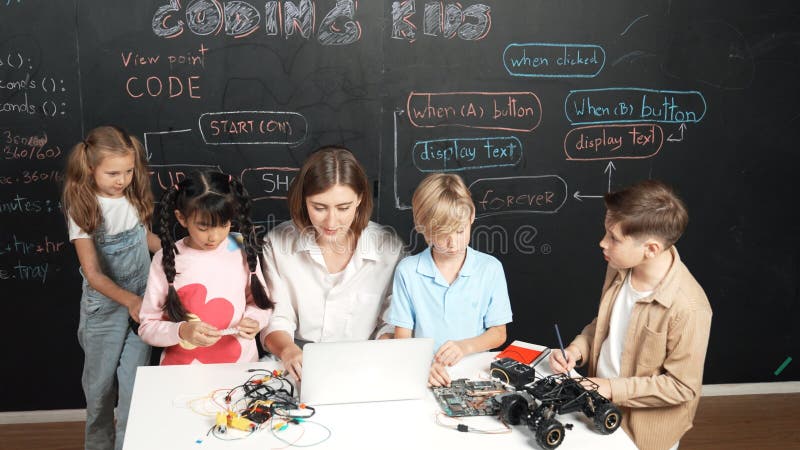 Diverse Student Writing Engineering Code while Boy Fixing Board ... Diverse Student Writing Engineering Code while Boy Fixing Board ...