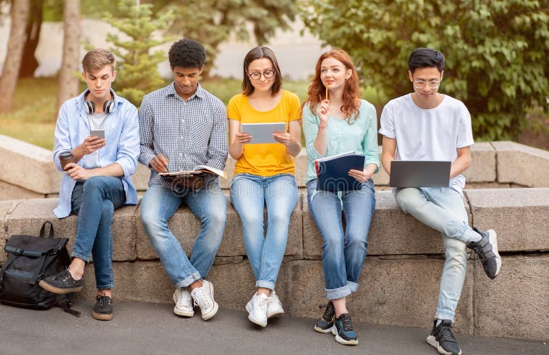 Diverse Students Learning Using Laptop and Tablet Computers Sitting ...