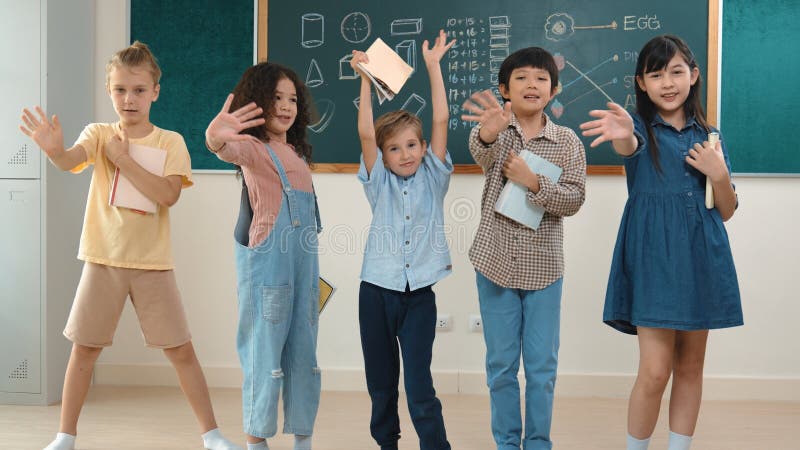 Diverse Students Looking at Camera while Waving Hands at Classroom ...