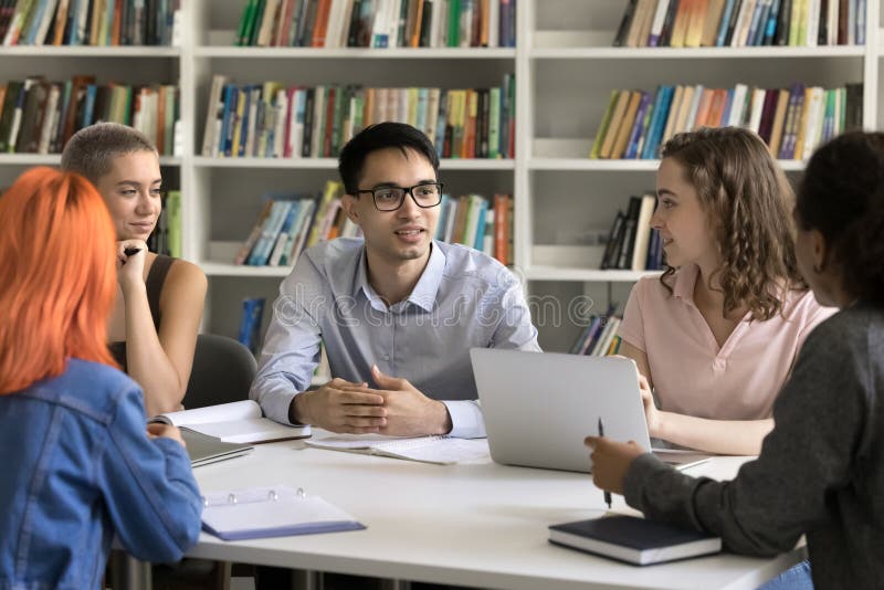 Diverse Students Share Ideas Engaged in Teamwork in College Library ...