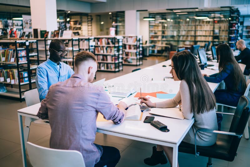 Multiethnic Students Studying in Looking Library Preparing for Seminar ...