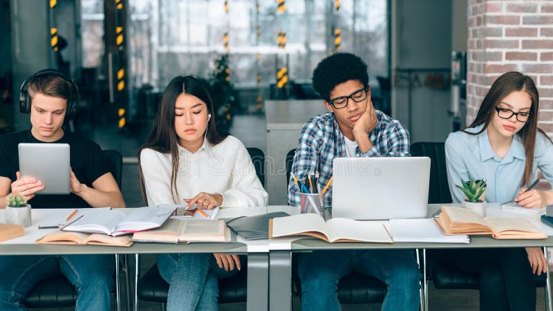 Diverse Students Studying in University Library with Gadgets Stock ...