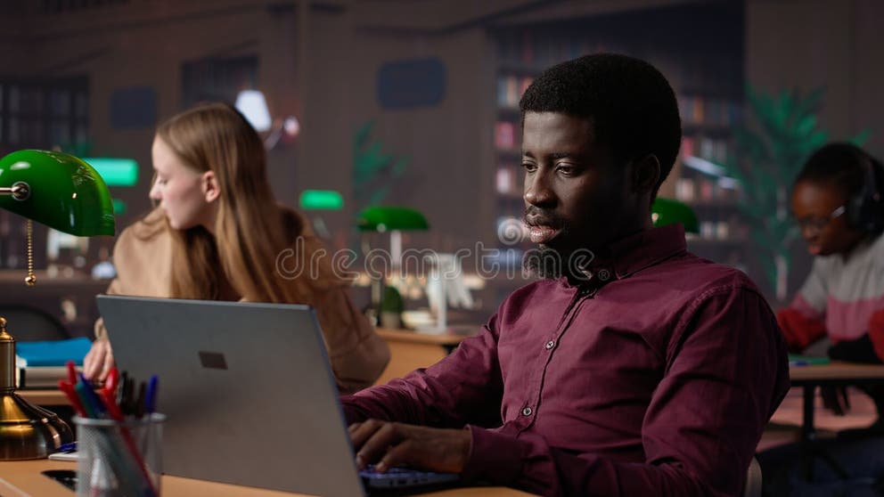 Diverse Students Working Together on a College Assignment at the ...