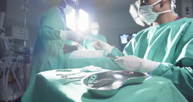 Diverse Surgeons Using Surgical Instruments in Operating Theatre at ...