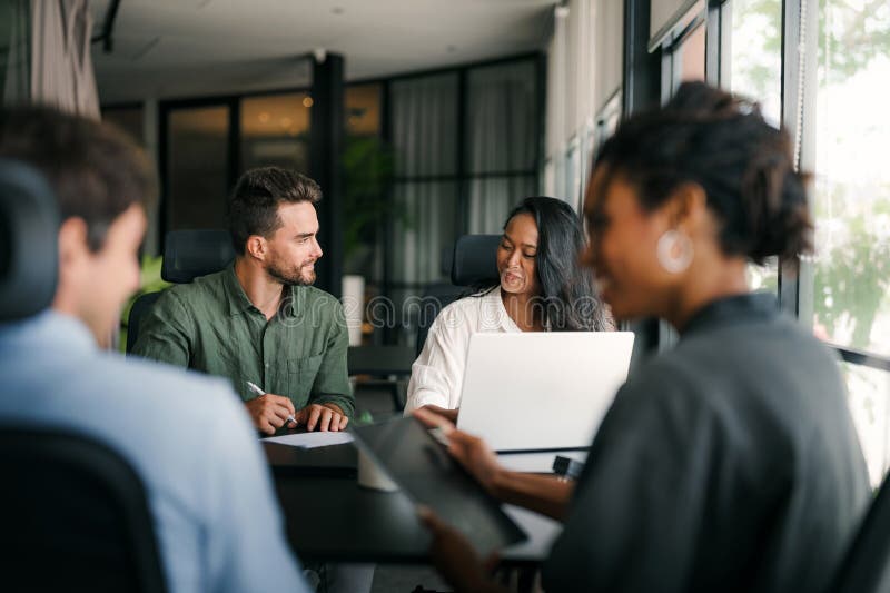 A Diverse, Talented Team Collaborates Effectively in a Bright Office ...