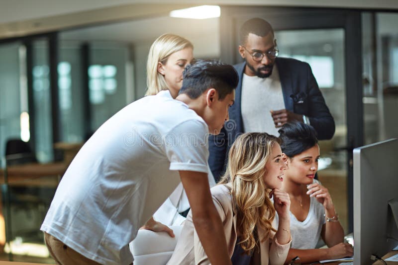 Diverse Team of Business People Looking at a Computer Screen Together ...