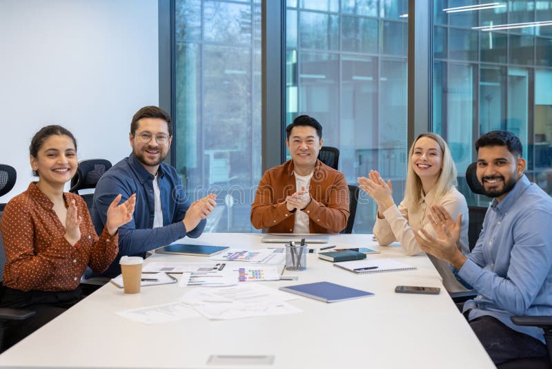 A Diverse Team Celebrates Success, Clapping Enthusiastically in a ...