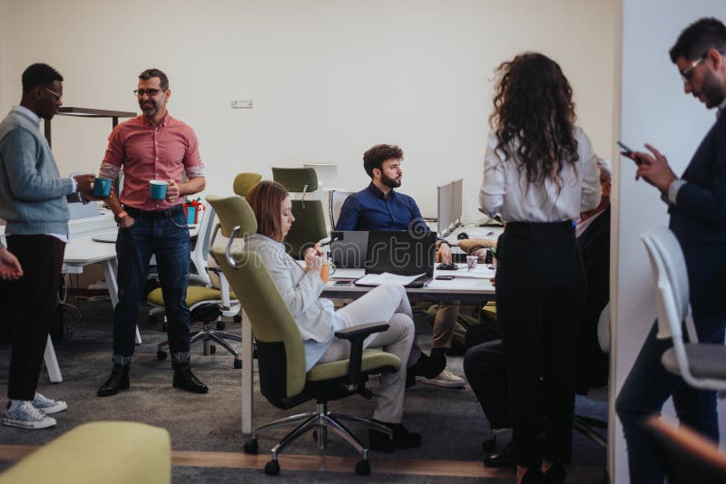 A Diverse Team Collaborates in a Modern Office, Leveraging Technology ...