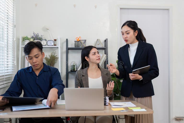 Team Brainstorming Solutions in a Modern Office, Highlighting Collaboration and Communication ...