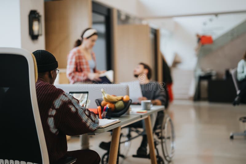 Diverse Team Collaborating in Modern Office Space with Wheelchair User ...